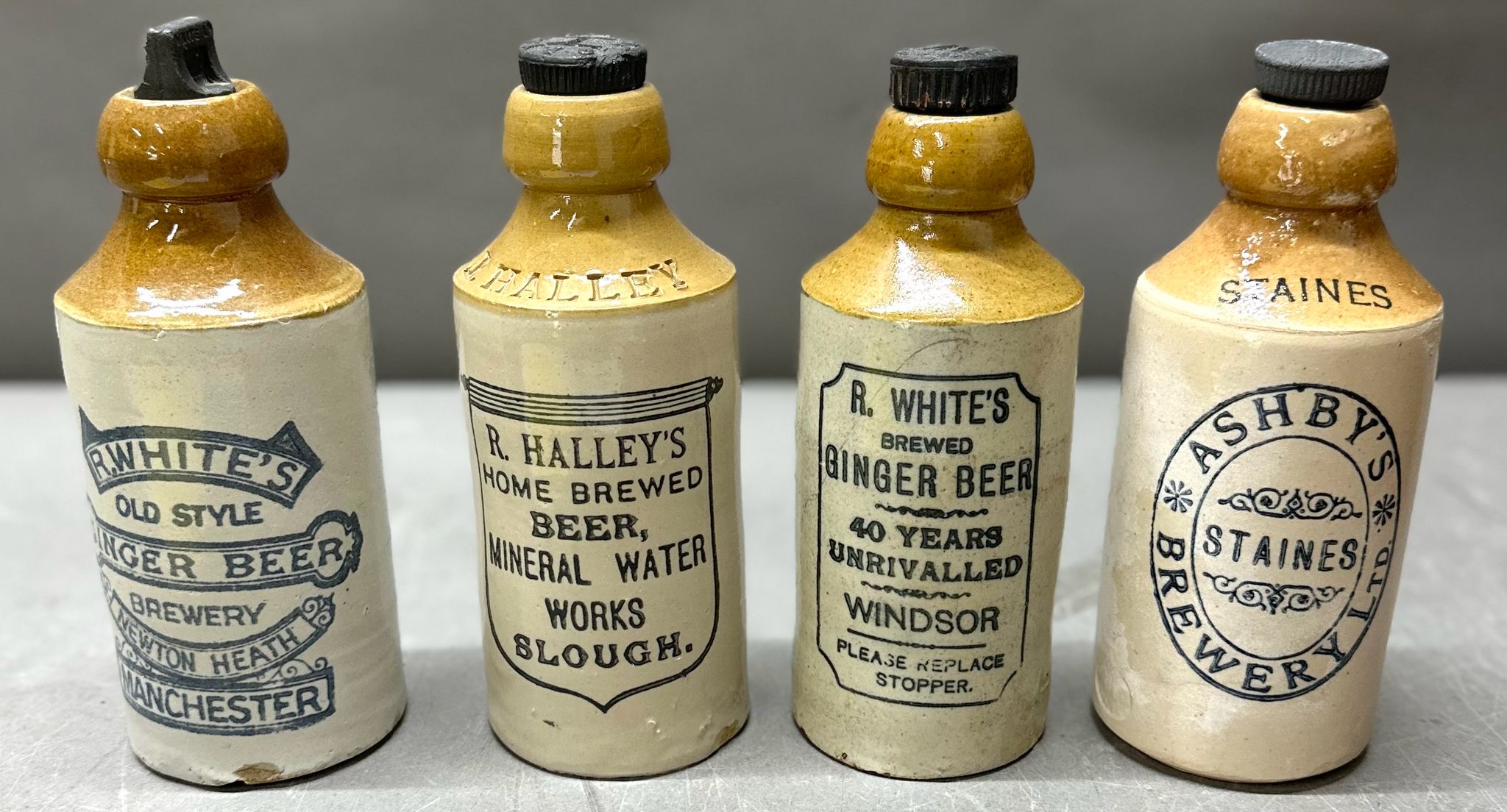 Lot 848 - Four antique stoneware ginmger beer bottles